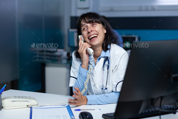 Doctor talking on landline phone for healthcare checkup Stock Photo by ...