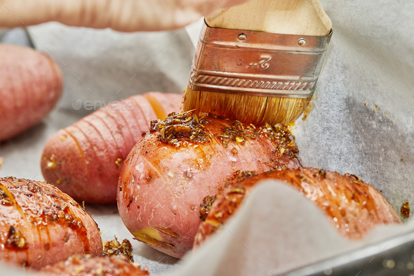 Hasselback Hedgehog potatoes, before roasting in the oven with herbs de ...