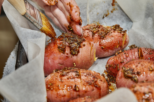 Hasselback Hedgehog potatoes, before roasting in the oven with herbs de ...