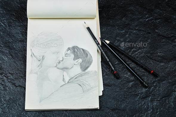 Drawing of men on the notebook in the dark background Stock Photo by ...