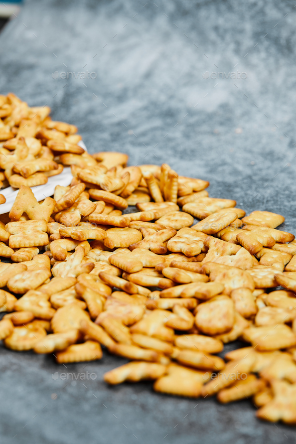 Scattered alphabet crackers on a marble background Stock Photo by 13people