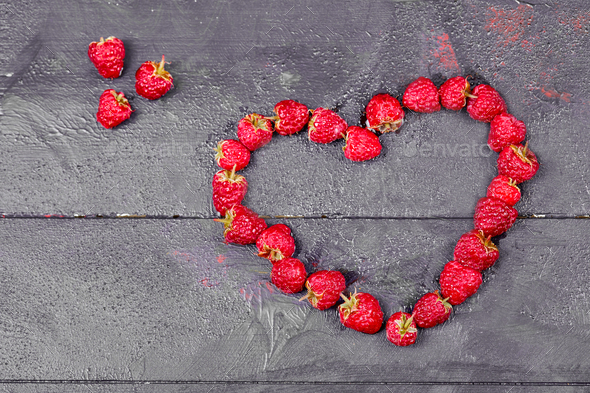 Heart shape made of sweet raspberries on the dark table Stock Photo by ...