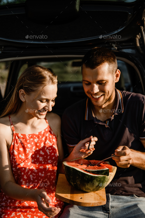 Young happy loving couple embracing and having fun together in car ...