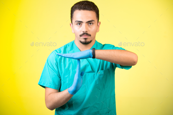 Doctor in uniform and hand mask using body language Stock Photo by 13people