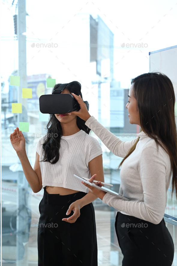 Team of developers testing virtual reality headset, brainstorming on ...