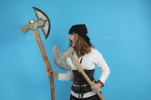 Angry young pirate holding war axes and screaming on blue background ...