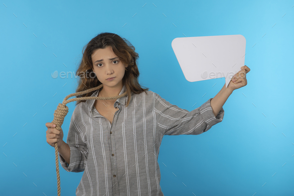 Young girl put a rope around her neck and holding white idea board ...