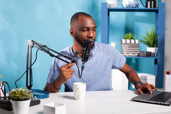 Vlogger answering questions talking at professional microphone in ...