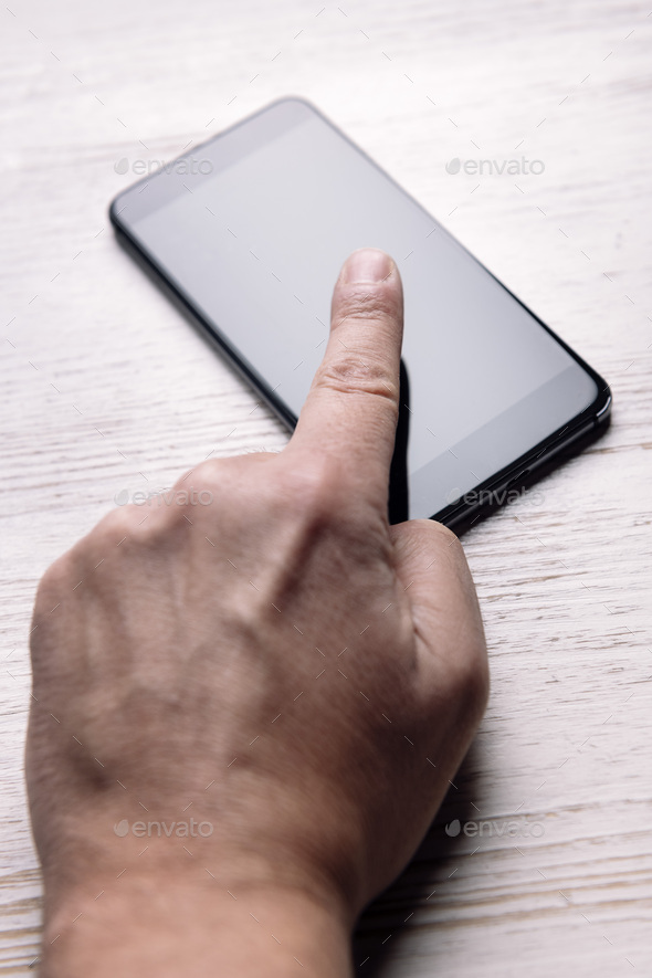 hand touching the screen of a smart phone Stock Photo by Raul_Mellado