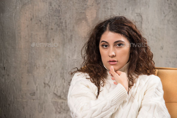 Photo of attractive lady sitting in comfy chair and posing Stock Photo ...