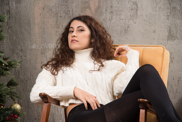 Photo of attractive lady sitting in comfy chair and posing Stock Photo ...