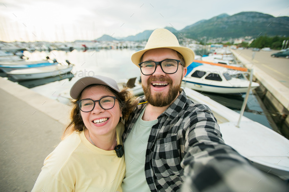 couple taking a self portrait laughing as they pose close together for ...