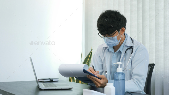 Doctor hand holding pen writing patient history list on clipboard about ...