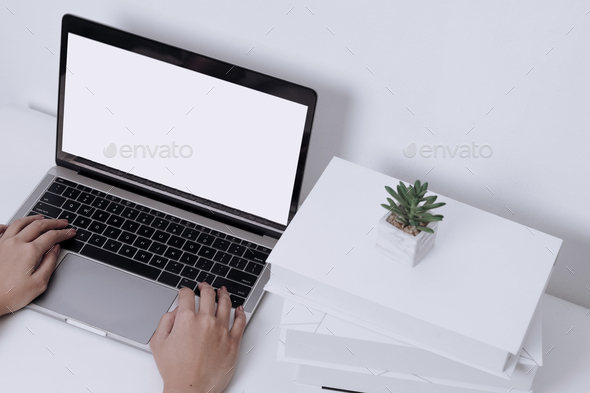 Placeit - Hand typing on blank screen laptop Stock Photo by Garakta-Studio