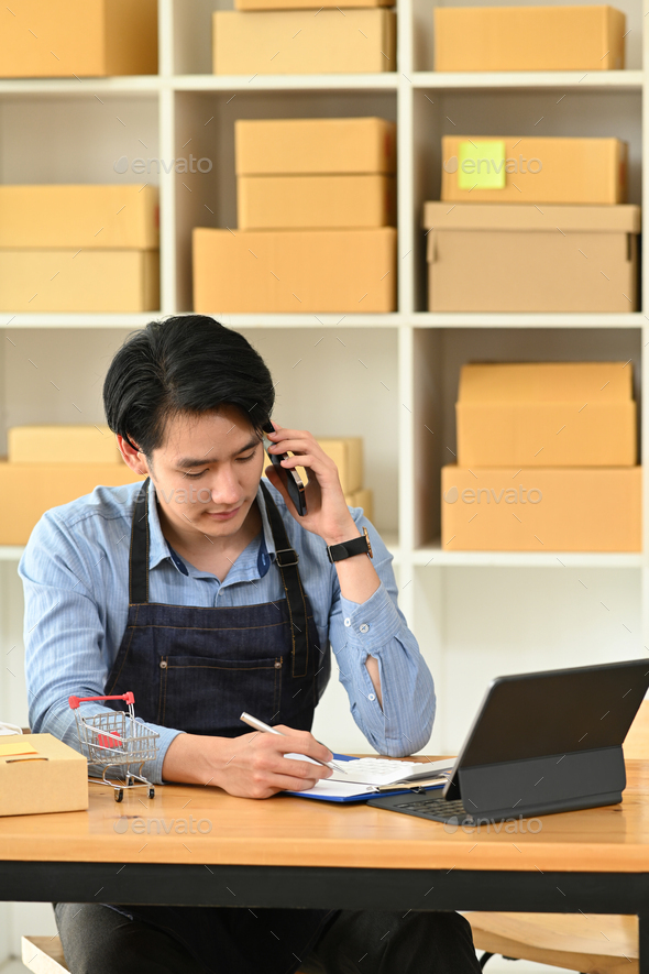 Startup small business owner using computer tablet and confirming ...