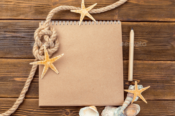 Shells and notepad on wooden table. Top view with copy space Stock ...