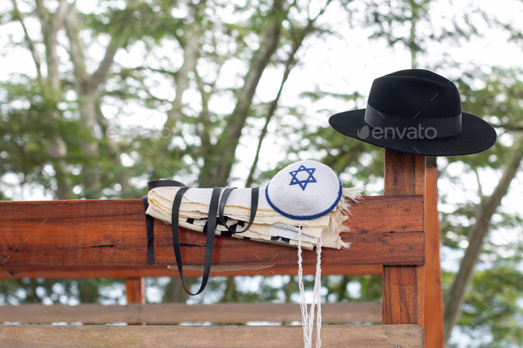 Jewish religious objects together on a wood. kipa, tallit, Tzitzit ...