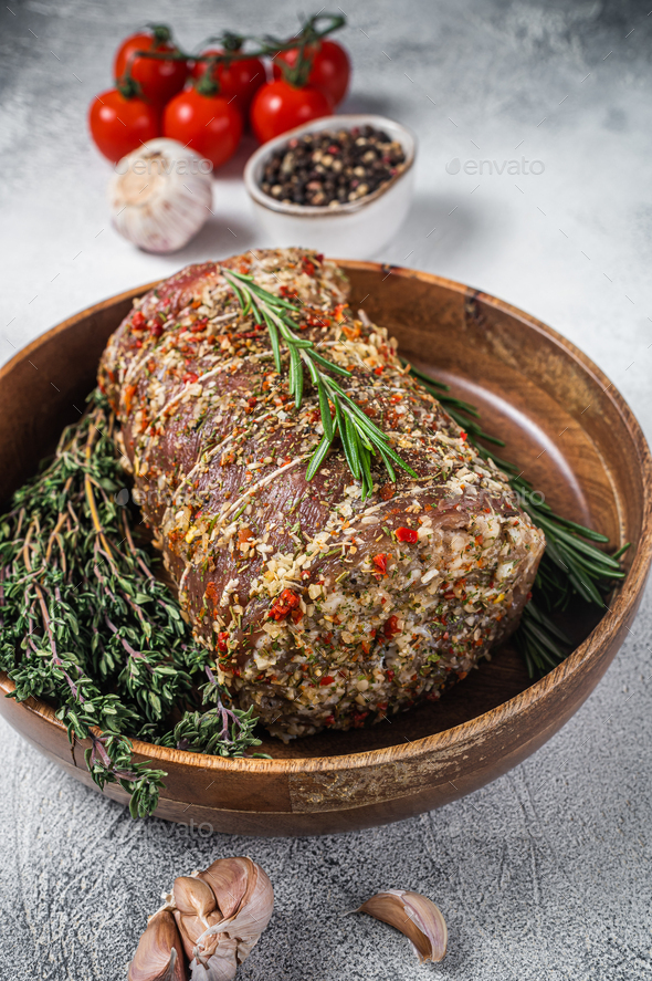 Raw italian Porchetta seasoned with herbs, pork meat roll. White ...