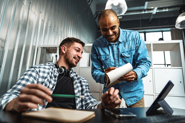 Two young men working together on a new business project in office ...