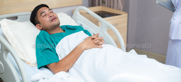 Asian male coma patient fully recovery sleeping on bed at the hospital ...