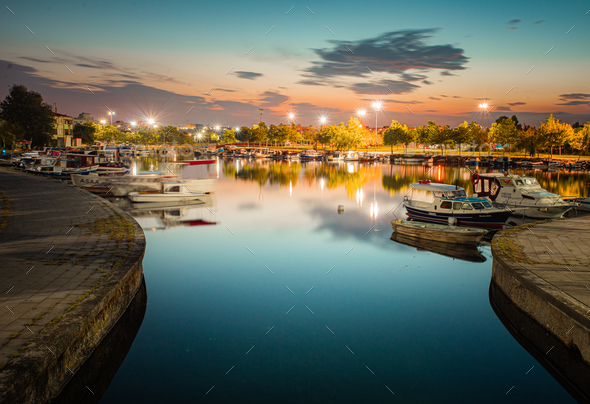 Reflection boats in the harbour at night Stock Photo by aissahaffar