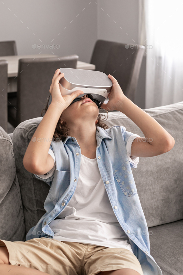 happy little boy child using virtual reality headset vr glasses ...