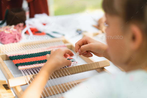 Girl weaving small rug with pattern at masterclass on weaving. Stock ...