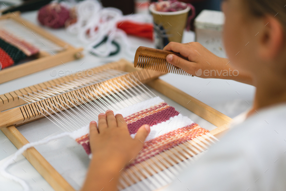 Girl weaving small rug with pattern at masterclass on weaving. Stock ...