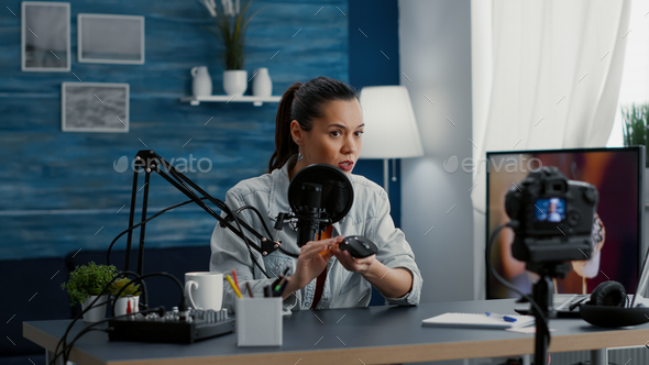 Tech influencer reviewing modern wireless mouse while presenting it to ...