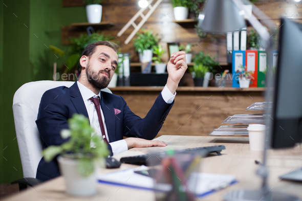 Handsome bearded businessman looking proud at computer monitor Stock ...