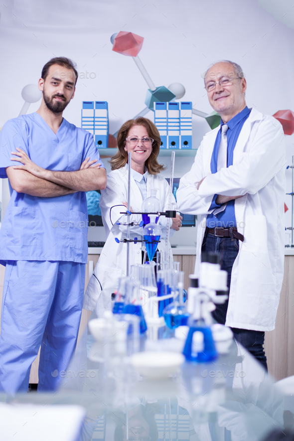 Portrait of researchers team with arms crossed smiling to the camera ...