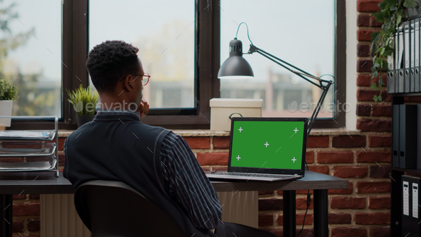 Business man working with laptop and green screen on display Stock ...