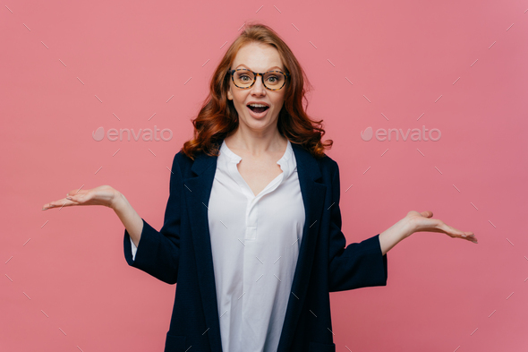 Half length shot of confused business lady raises palms, has hesitant ...