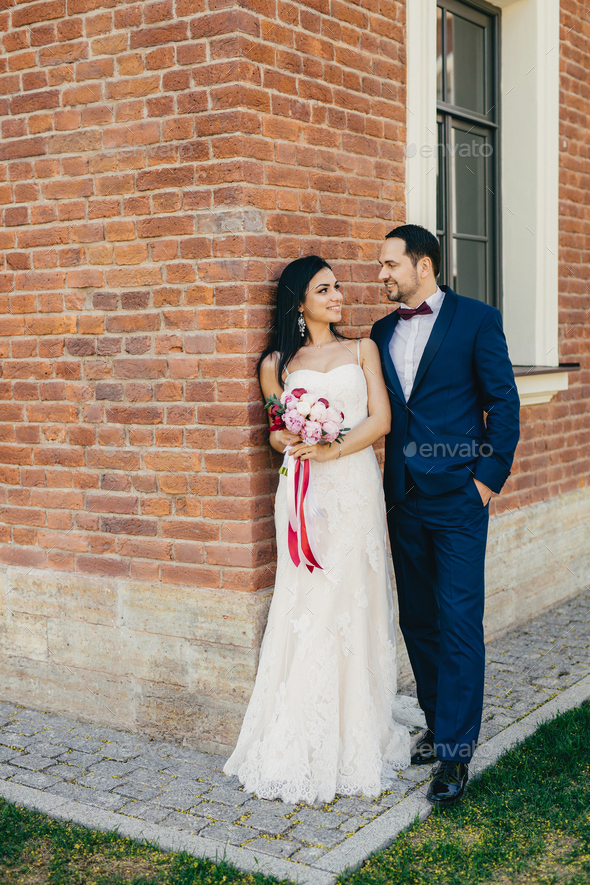 Handsome male bridegroom looks with great love at his bride Stock Photo ...