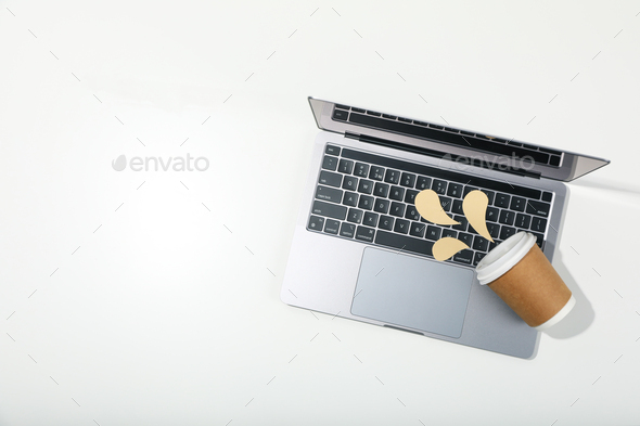 Concept of spilled drink, paper cup and decorative liquid on laptop ...