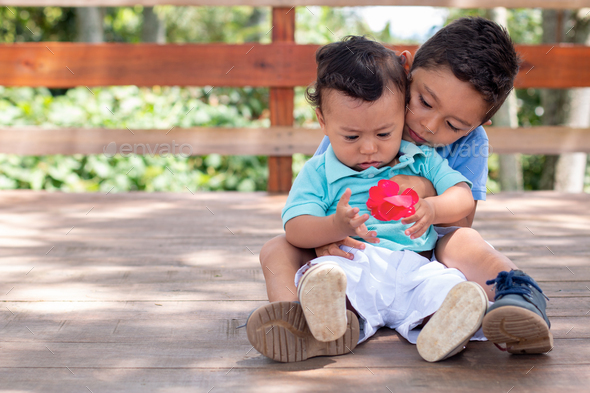 Big brother taking care of his little brother.Portrait of two little ...