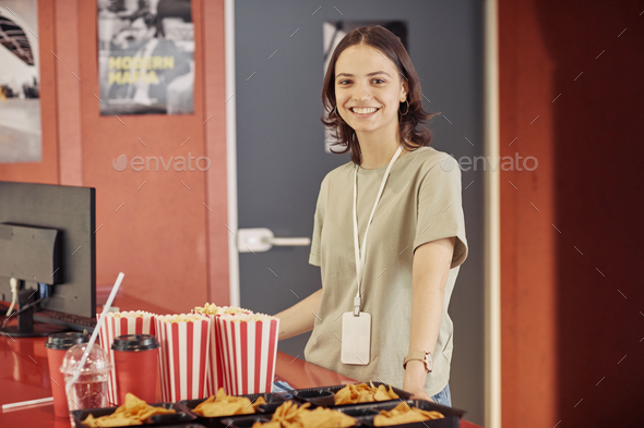 Seller selling popcorn at cinema Stock Photo by seventyfourimages ...