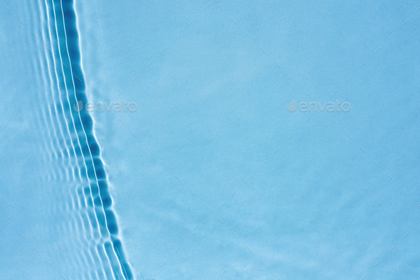 Straight vertical wave, ripples on surface of transparent blue clear ...