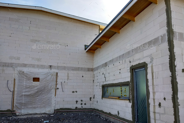 Facade of white block building under construction works. Stock Photo by ...