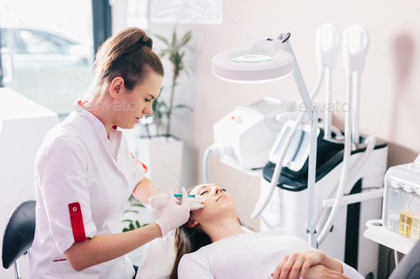 Injectable tissue stimulator on woman face in beauty salon Stock Photo ...