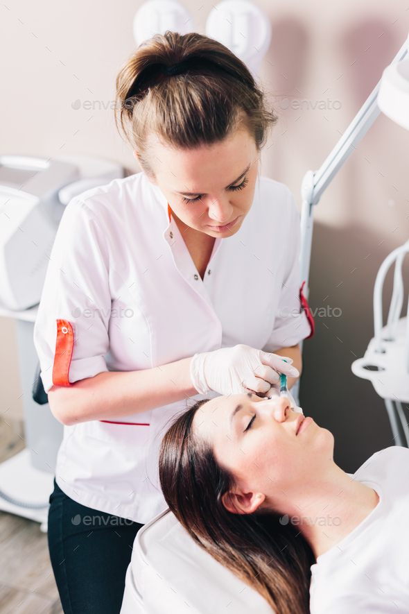 Injectable tissue stimulator on woman face in beauty salon Stock Photo ...