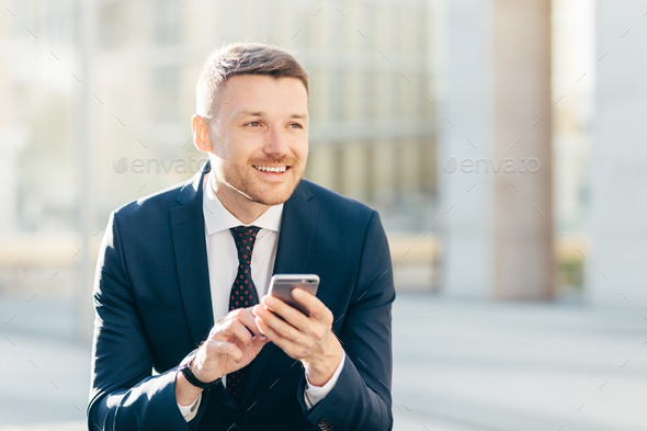 Delighted thoughtful elegant male marketing trader in formal black suit ...