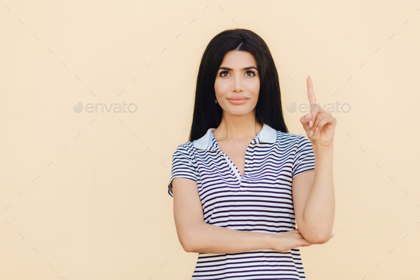 Horizontal portrait of attractive female with dreamy expression, has ...