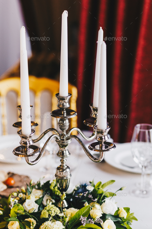 Luxurious banquet table served with beautiful candlestick with white ...