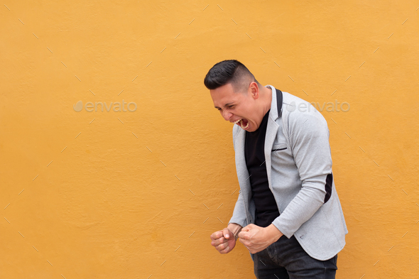 Man shouting a victory by clenching his fists and screaming at the top ...