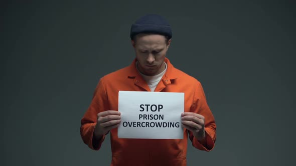 Prisoner Holding Stop Prison Overcrowding Sign in Cell, Life Conditions ...