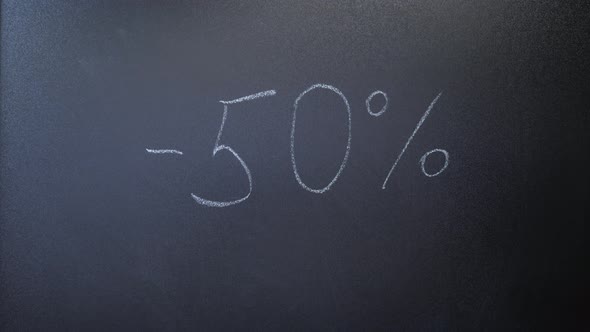 50% promotion discount offer written on chalkboard. Hand writing -50% ...