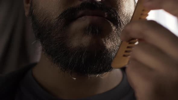 Close Up Of Ethnic Minority Adult Male Combing Beard. Locked Off , Half ...