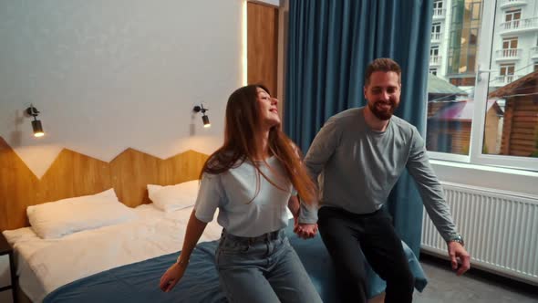 Young couple in hotel room fall on bed, Stock Footage | VideoHive