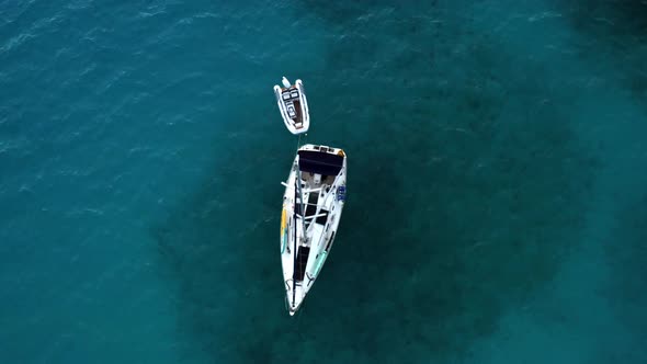 Top Down Aerial View of Deserted Anchored Sailboat and Motorboat in ...